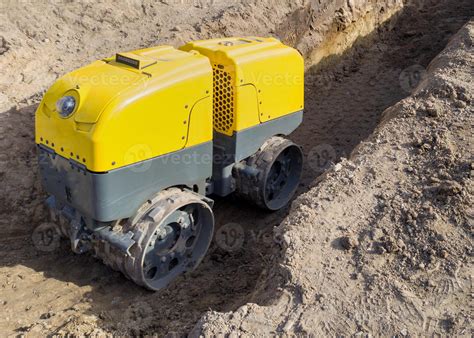 Remote Controlled Yellow Trench Compactor At Construction Site 51779769