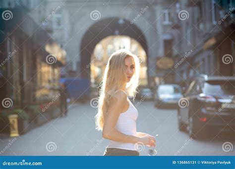 Seductive Young Model With Long Hair Holding Glasses Posing At The