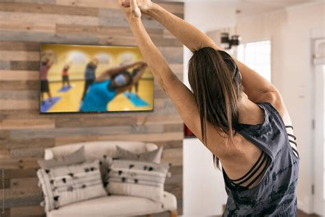 Home Woman In Virtual Stretching Exercise Class By Stocksy