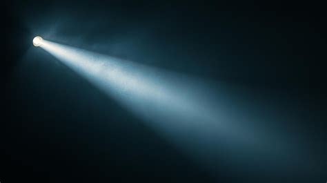 A Beam Of Light Cutting Through Darkness In A Dimly Lit Environment At
