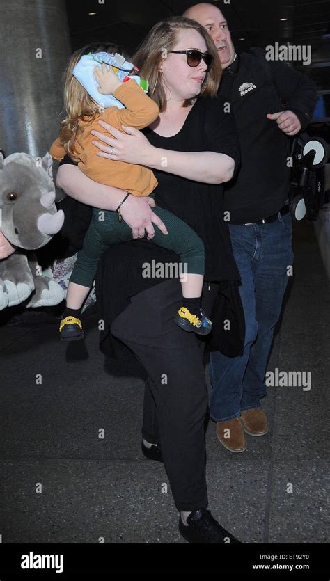 Adele Arrives At Los Angeles International Lax Airport Carrying Her