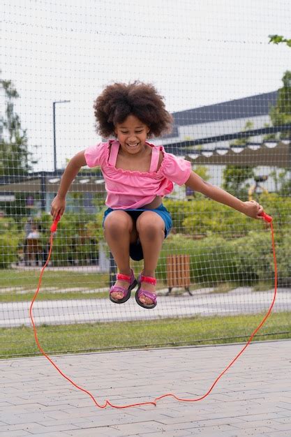 Full Shot Happy Girl With Red Rope Free Photo