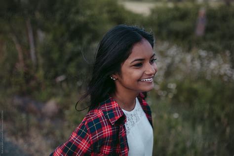Portraits Of Young South Asian Girl Enjoying Being Outside By Stocksy