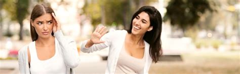 Premium Photo Shy Girl Avoiding Meeting Friend Having Communication Problems Walking Outdoors