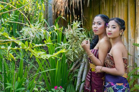 Balinese Girls With Bare Shoulders In Traditional Costume At Bali And