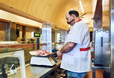 Butcher Man And Scale In Store For Meat With Reading Check And Career
