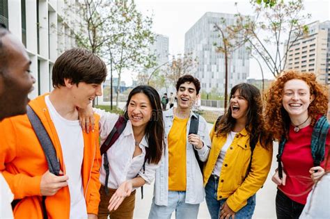 Young Group Of Teenagers Talking After High School Classes Stock Image