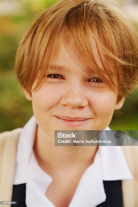 Portrait Of Lilt Blonde Teenage Girl With Short Haircut In School