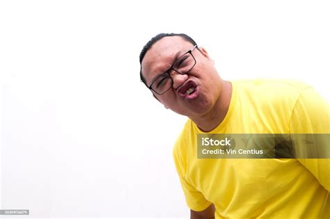 Adult Asian Man Showing Funny Ugly Face Expression To Express His Bad