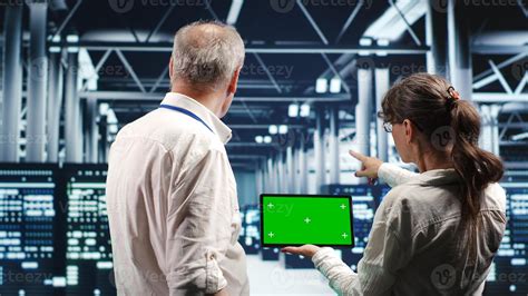 Specialists Using Mockup Tablet To Monitor Energy Efficient Data Center Clusters Server Units