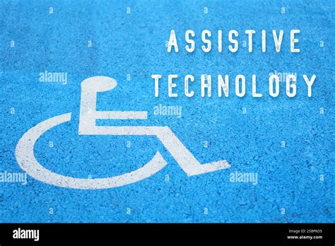 Assistive Technology Concept Written Words On Blue Pavement Background With Disability Icon