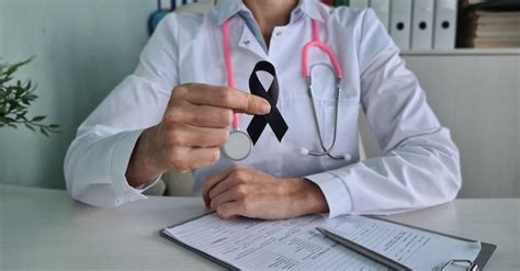 Premium Photo Awareness Of Black Tape In Doctor Hand For Melanoma And