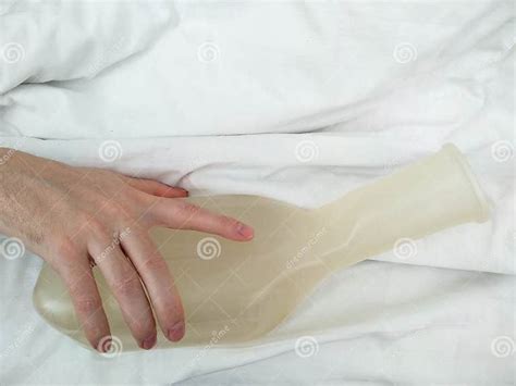 Male Hand Holds Urinal Pot In The Hospital Lying Patient After Surgery