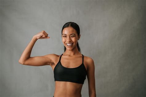 Premium Photo Young Multi Ethnic Woman Very Proud Of Her Toned Arm Muscle