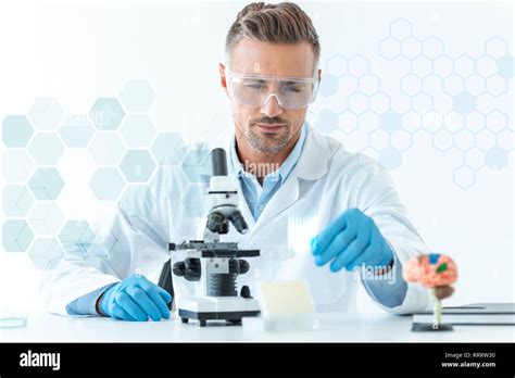 Selective Focus Of Handsome Scientist In Protective Glasses Making