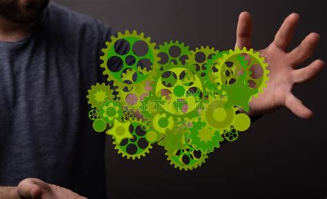 man holding the green cogwheel icons in his hand big data concept stock image image of