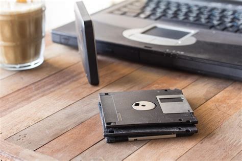 Premium Photo Close Up Of Floppy Disk By Laptop On Table