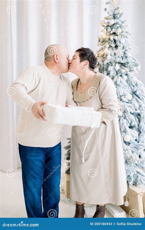 Happy Kissing Cheerful Couple Mature Wife And Husband Hugging And