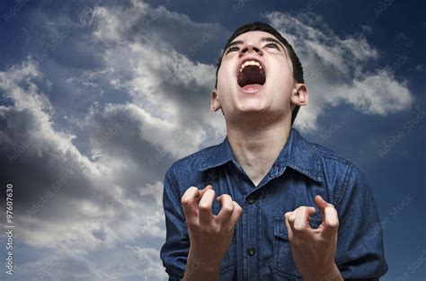 Boy Screamingangry Caucasian Teenager Screaming Wildly On A Cloudy Sky