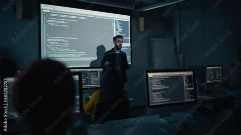teacher giving computer science lecture to diverse multiethnic group of