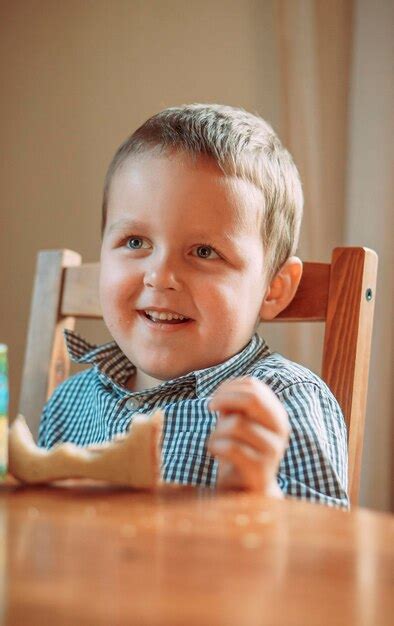 Premium Photo Portrait Of Boy Sitting On Table