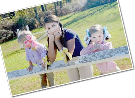 Download Three Girls Leaningon Fence Outdoors