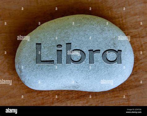 Libra Zodiac Sign Text Engraved On A Stock With Wooden Background