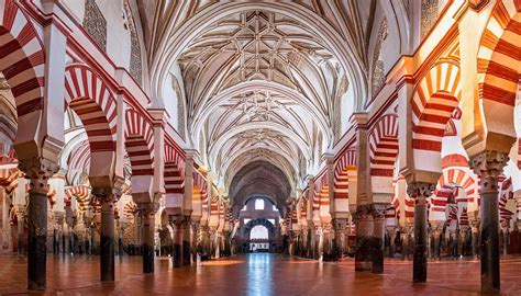 Interior Of The Great Mosque Of Cordoba With Iconic Redandwhite Arches