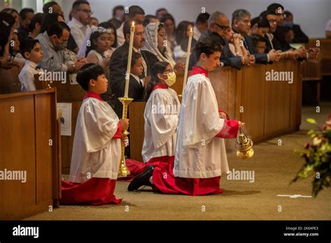 On Their Knees Multiracial Altar Boys Participate In A Catholic Mass