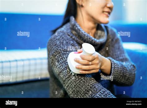 Relax And Massage Electric Arm Neck And Shoulder Massage Machine On Women Arm Closeup