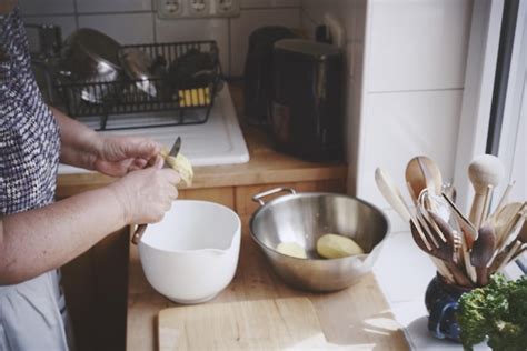 Premium Photo Woman Peeling Potatoes