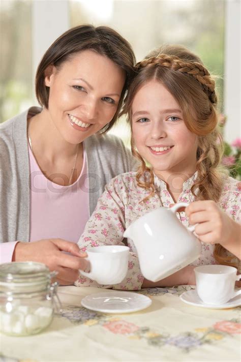 Mother And Daughter Drinking Tea Stock Image Colourbox