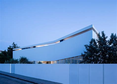 J House By Pitsou Kedem Features A Raised Roof Latticed Walls And A Bridge