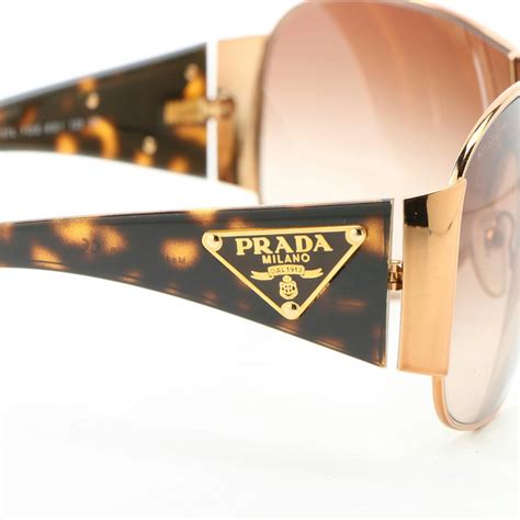 Prada Spr 57l Shield Sunglasses In Tortoise And Gold Tone Ebth