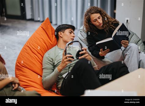 High School Students Relaxing While Studying Together Inside A
