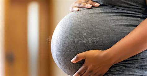 Cherishing The Journey Young Pregnant Woman Holding Belly With Love