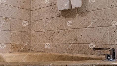 A Fragment Of A Bathroom In Beige Tones A Triangular Bathtub Is