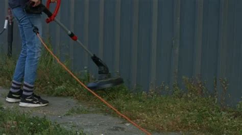 Young Person Weed Whacking Front Of Comm Stock Video Pond5