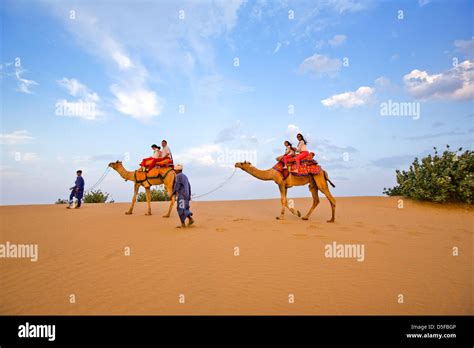 Tourists Enjoying The Camel Safari In A Desert Thar Desert Jaisalmer