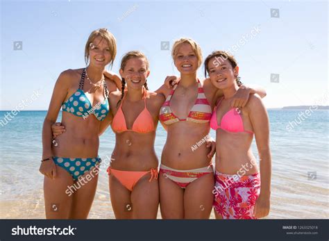 Стоковая фотография 1263325018 Teenage Girls Bikinis By Ocean On