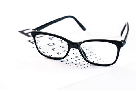 Eyeglasses With Eye Test Table On White Optometrist Concept And Eye