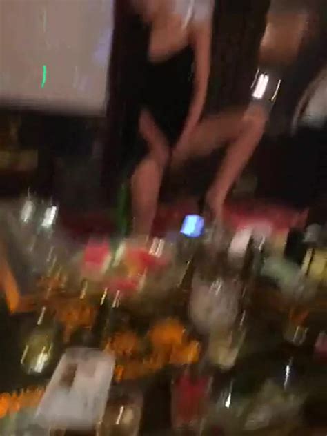 Chinese Waitress Serving A Bottle Of Beer