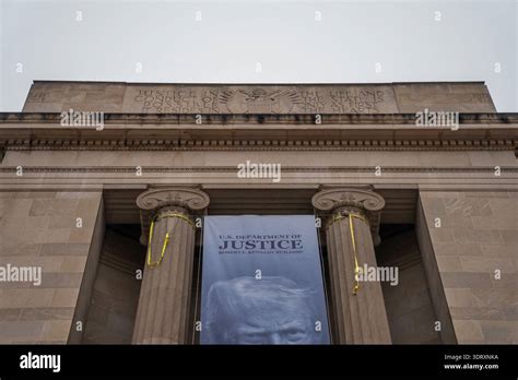 A Banner Showing President Donald Trump Is Hung From The Department Of