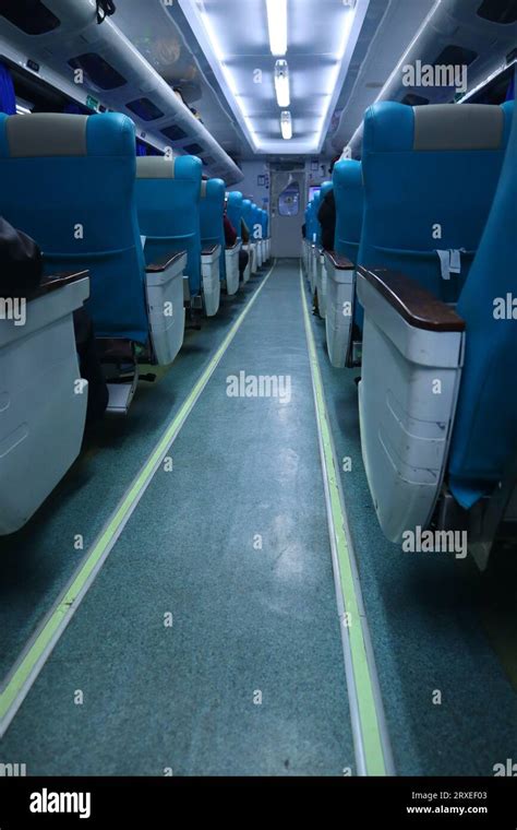 Executive Class Train Interior With Blue Seats Armrests Luggage Racks Monitor Screens Air