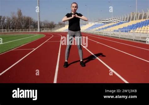 Active Young Attractive Fit Female Athlete Doing Squats Warm Up Stretch