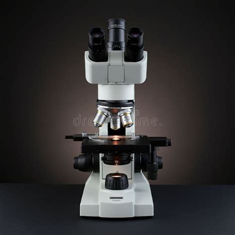 Laboratory Microscope With A White Body And Black Stage Featuring Dual Eyepieces Stock