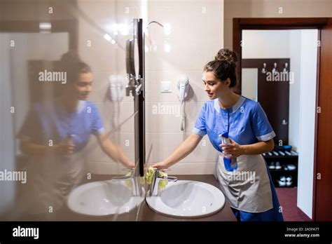 Contemporary young chamber maid with detergent cleaning sink in ...