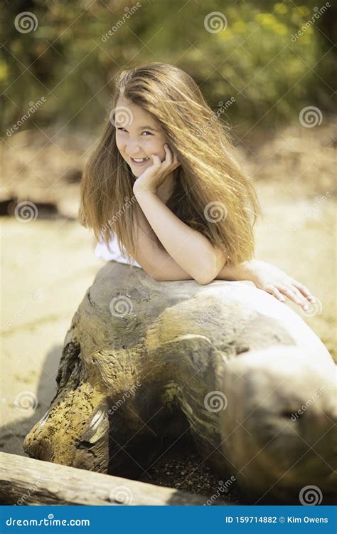 Cute Young Girl Sitting In The Sun At The Beach In Benicia Ca Stock