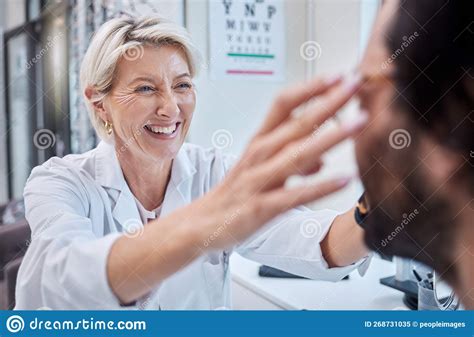 Optometrist Woman Examining The Eyesight Of Another Woman With A Slit