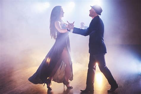 Premium Photo Skillful Dancers Performing In The Dark Room Under The Concert Light And Smoke